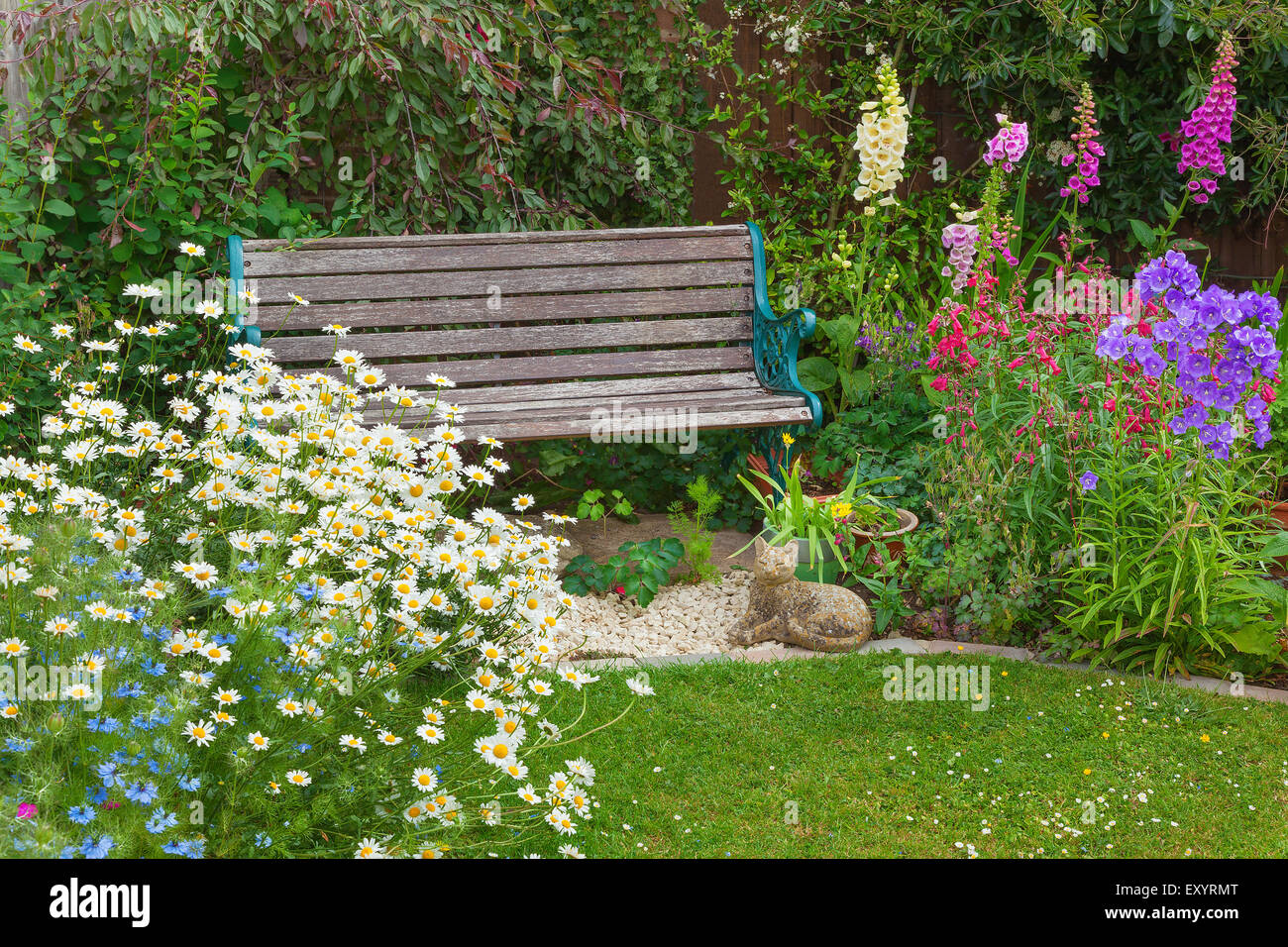 Cottage garden with bench and mixed flowers Stock Photo - Alamy