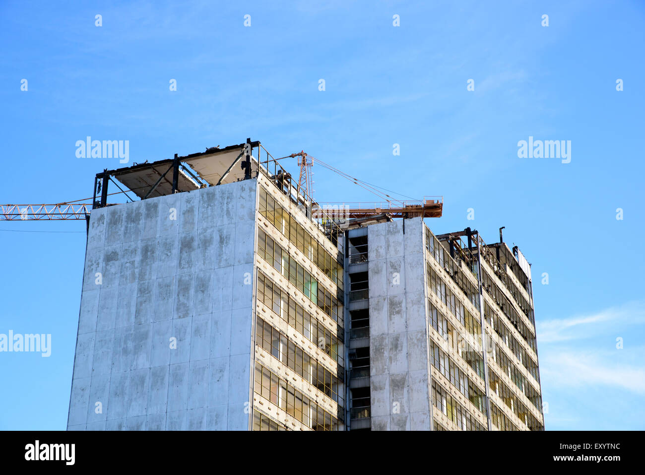 photo showing the demolition of a skyscraper with a high crane Stock ...