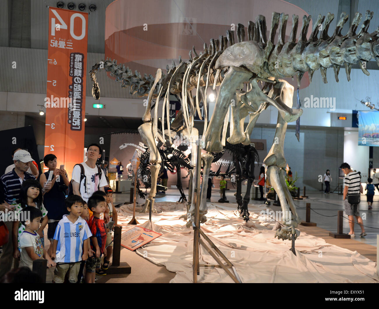 Tokyo, Japan. 18th July, 2015. People look at a dinosaur skeleton ...