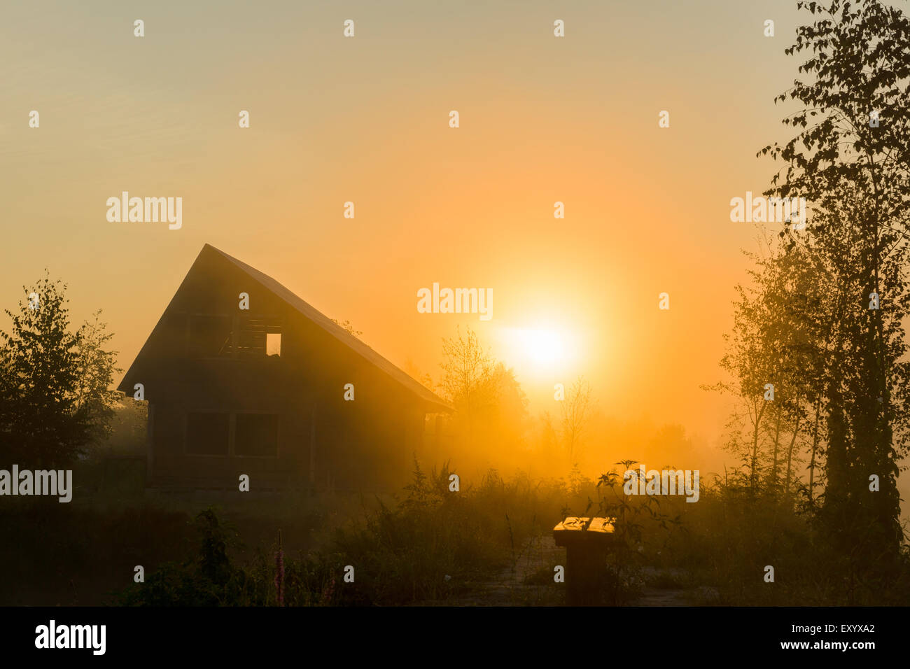 the sun early in the morning rises over a lodge Stock Photo - Alamy