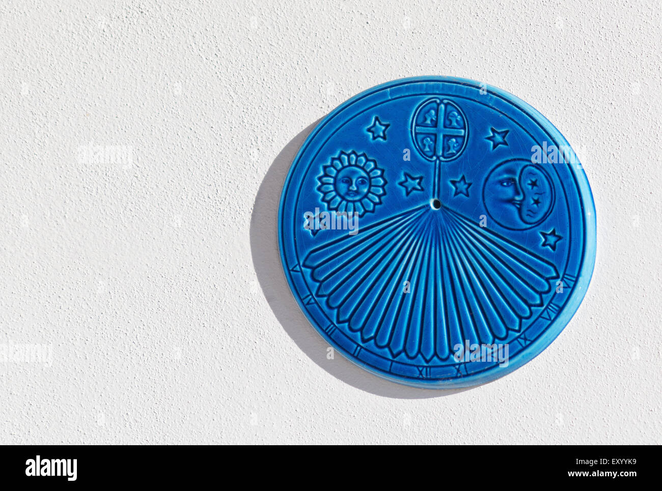 blue ceramic sundial on a white wall Stock Photo - Alamy