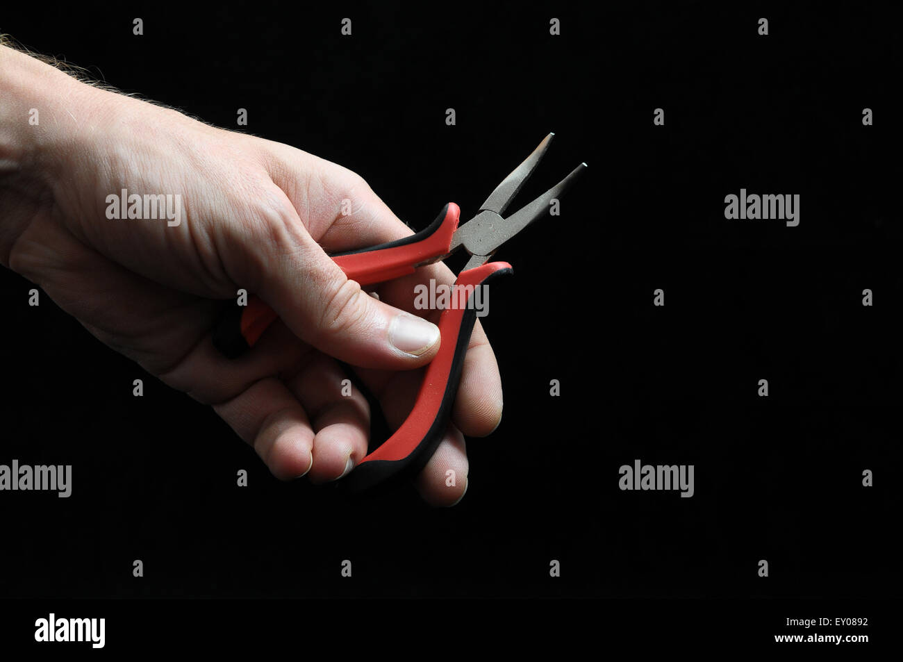 Pliers and a Hand Stock Photo - Alamy