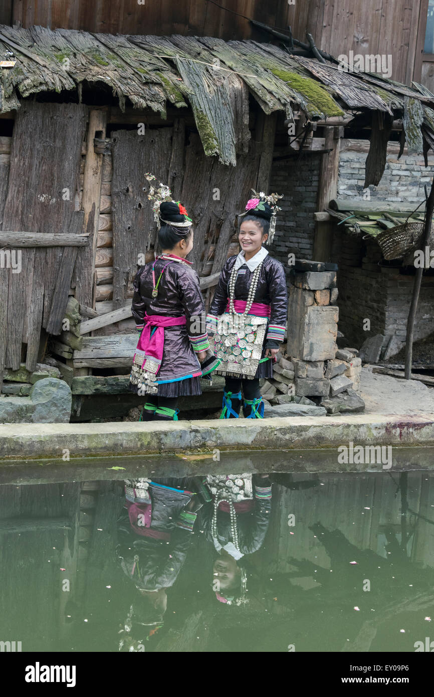 Front and back views of Dong girls in traditional attire with ...