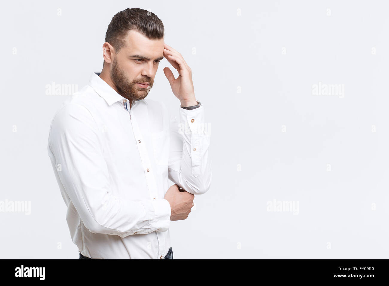 Portrait of man thinking hard Stock Photo - Alamy