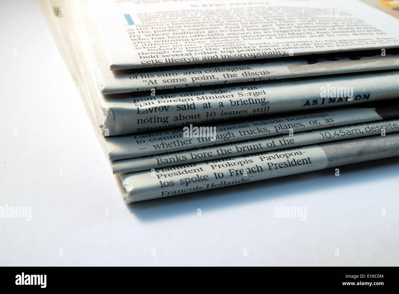 Close-up Stack of newspapers on white background Stock Photo - Alamy