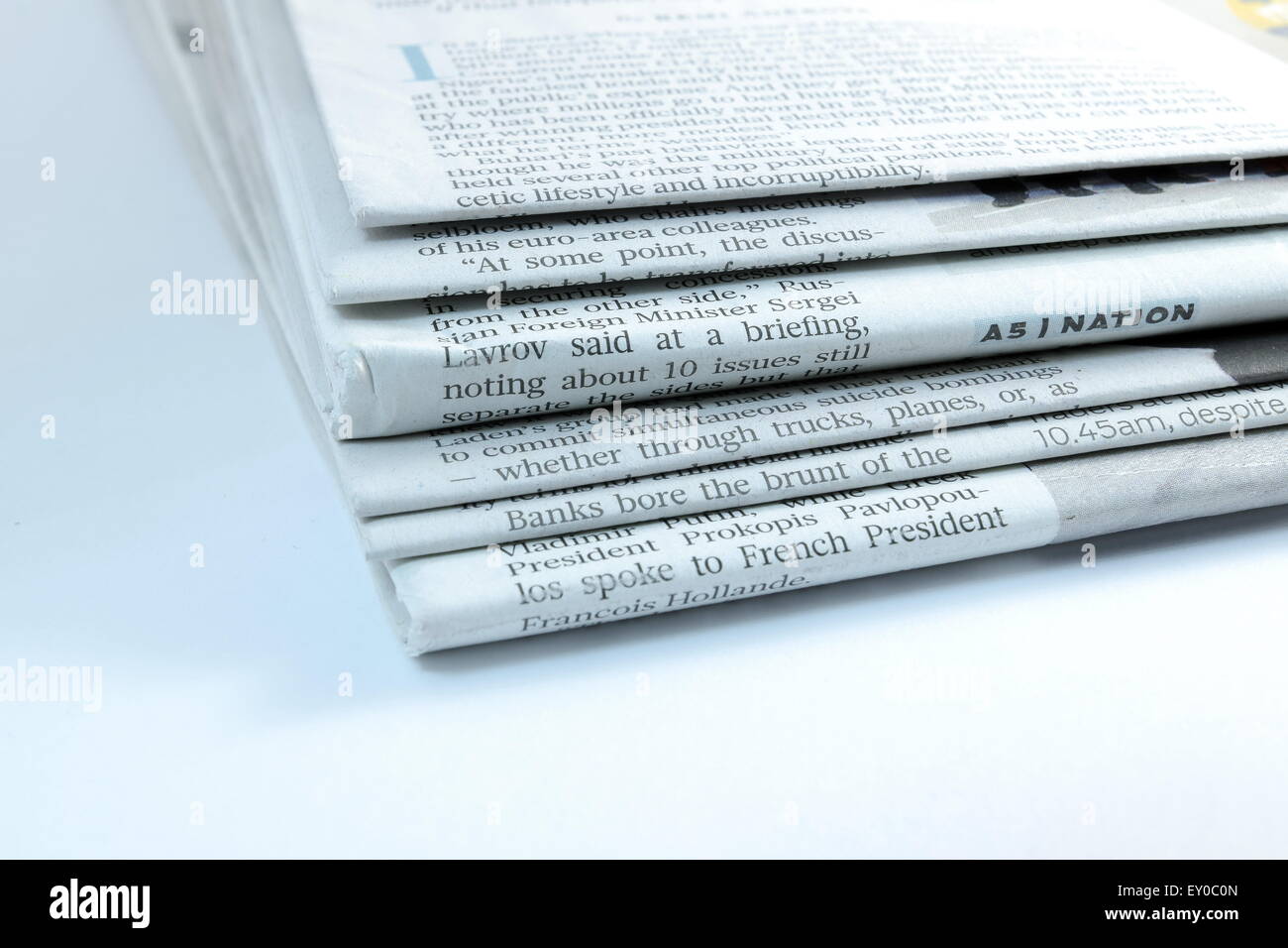 Close-up Stack of newspapers on white background Stock Photo - Alamy