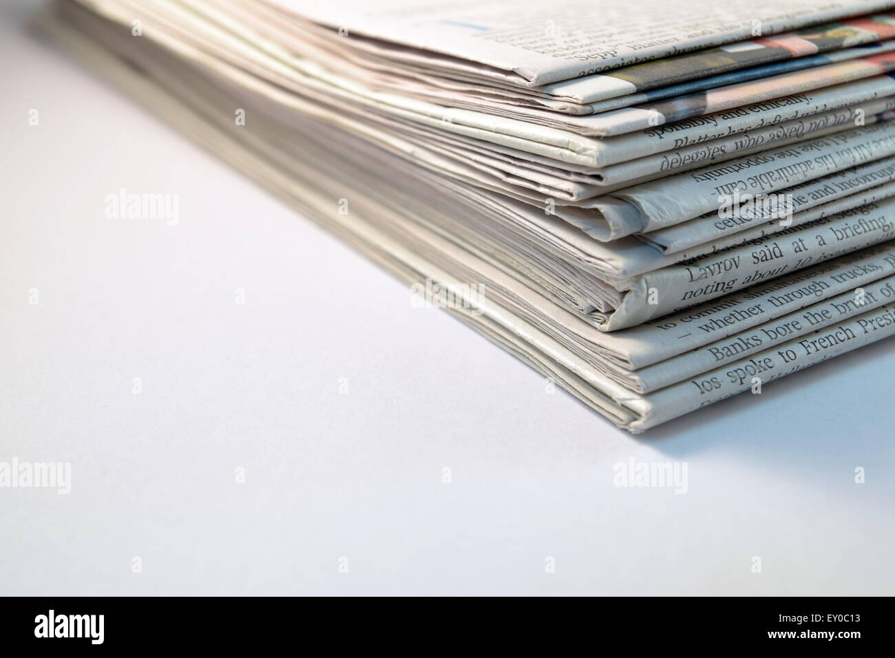 Close-up Stack of newspapers on white background Stock Photo - Alamy