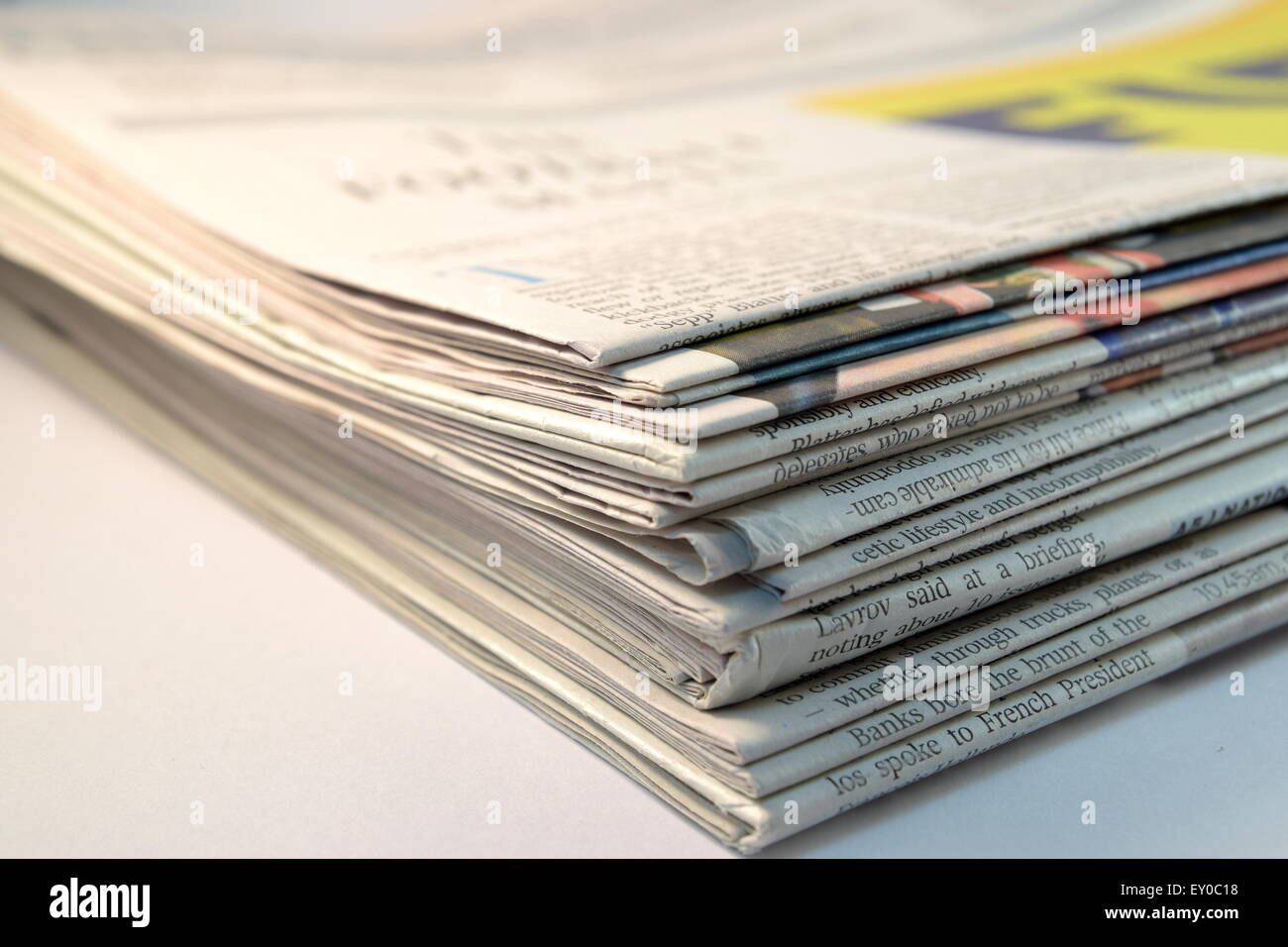 Close-up Stack of newspapers on white background Stock Photo - Alamy
