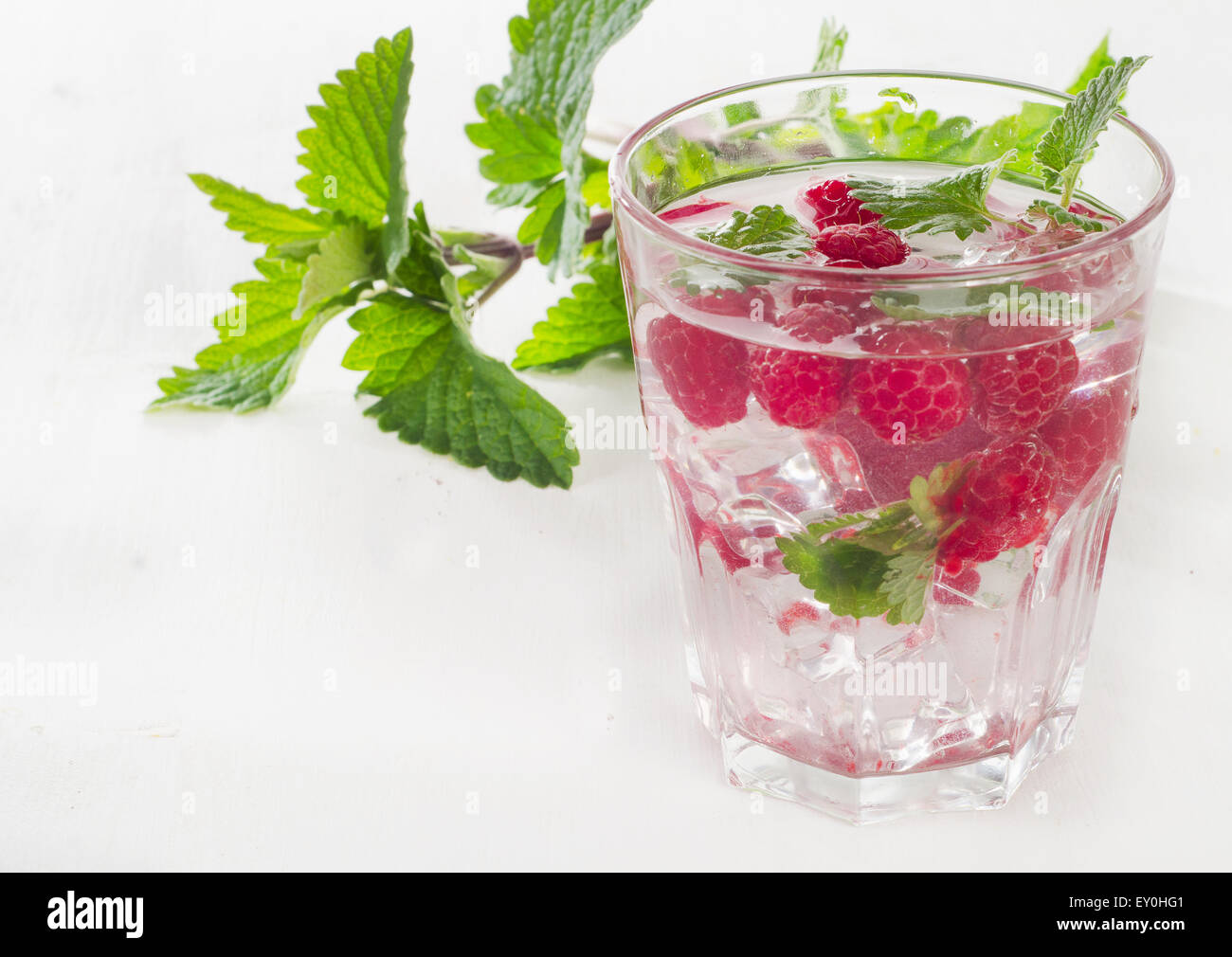 Summer cold drink with raspberries, ice and fresh mint leaves ...