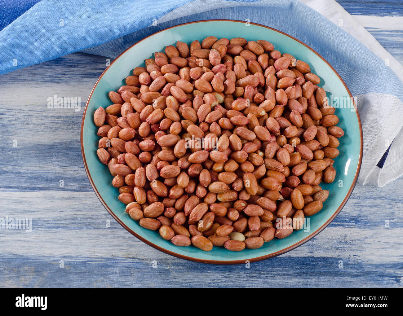 Peanuts on blue plate . Top view Stock Photo - Alamy