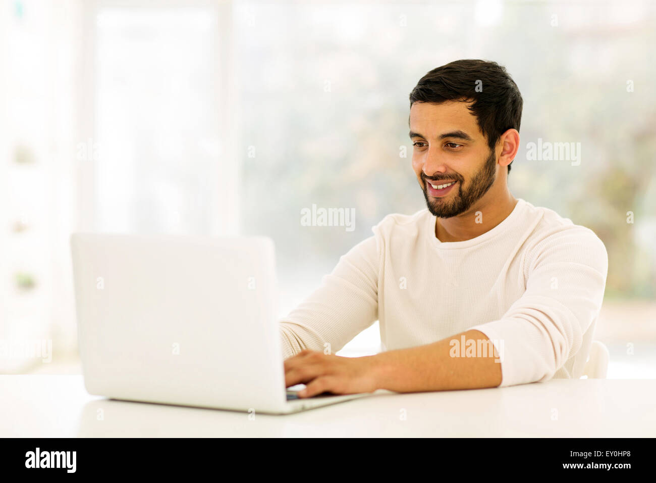 smiling young Indian man using laptop at home Stock Photo - Alamy