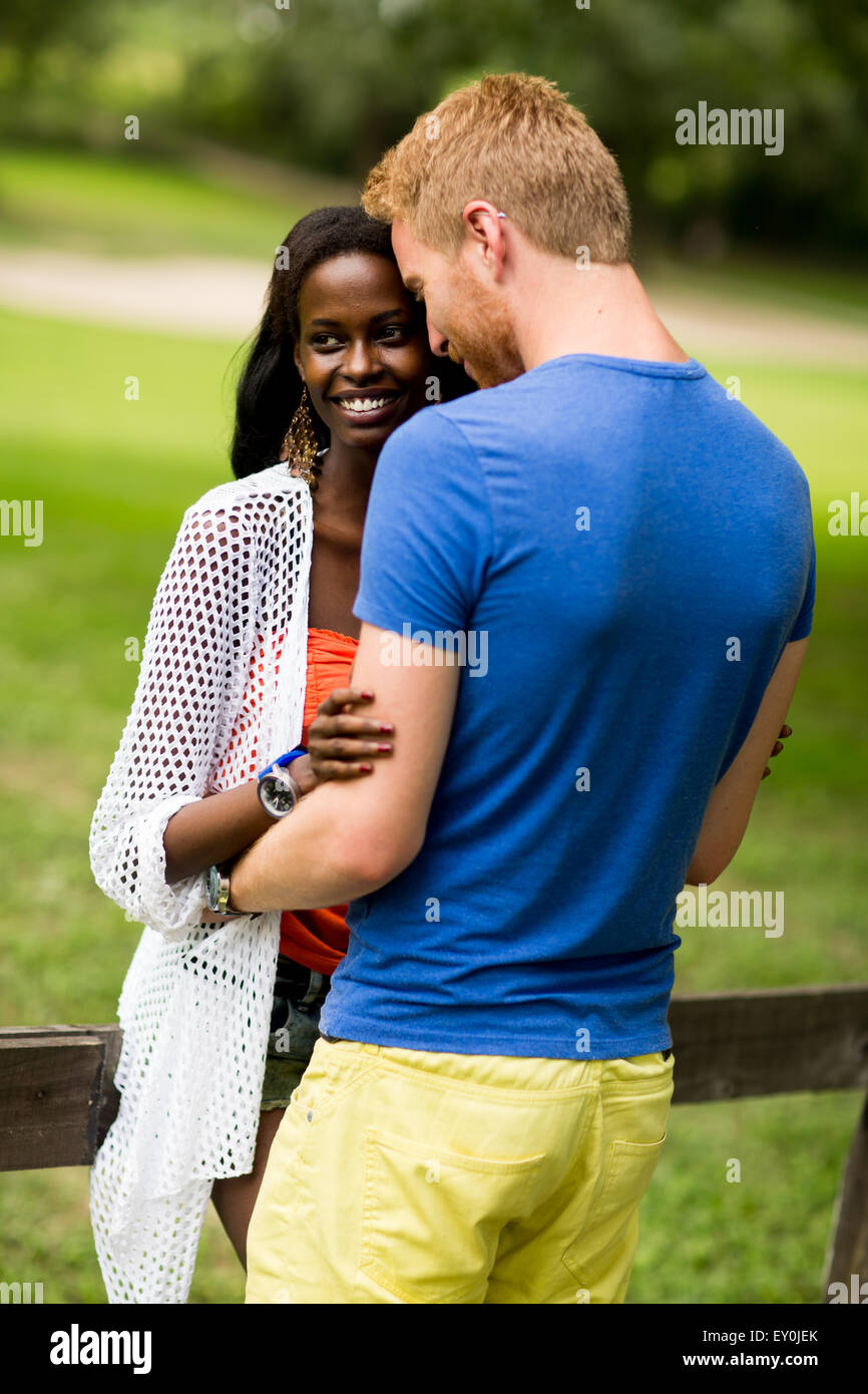 Multiracial couple in the park Stock Photo - Alamy