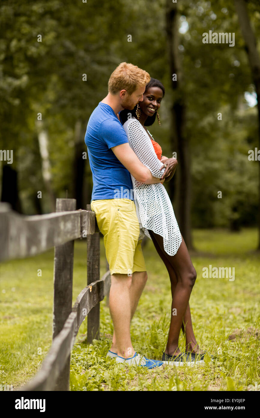 Multiracial couple in the park Stock Photo - Alamy