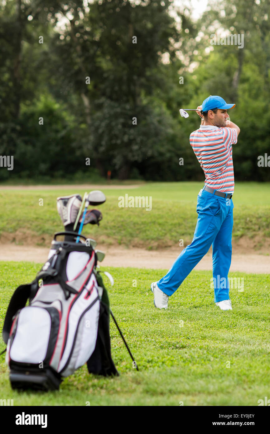 Young man playing golf Stock Photo - Alamy