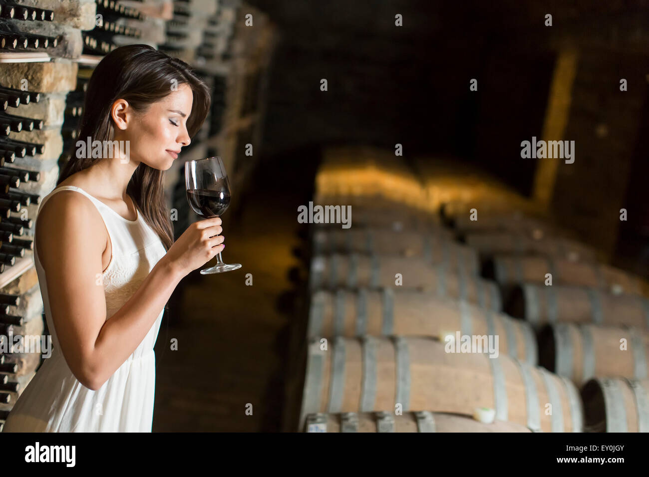 Young woman in the wine cellar Stock Photo - Alamy