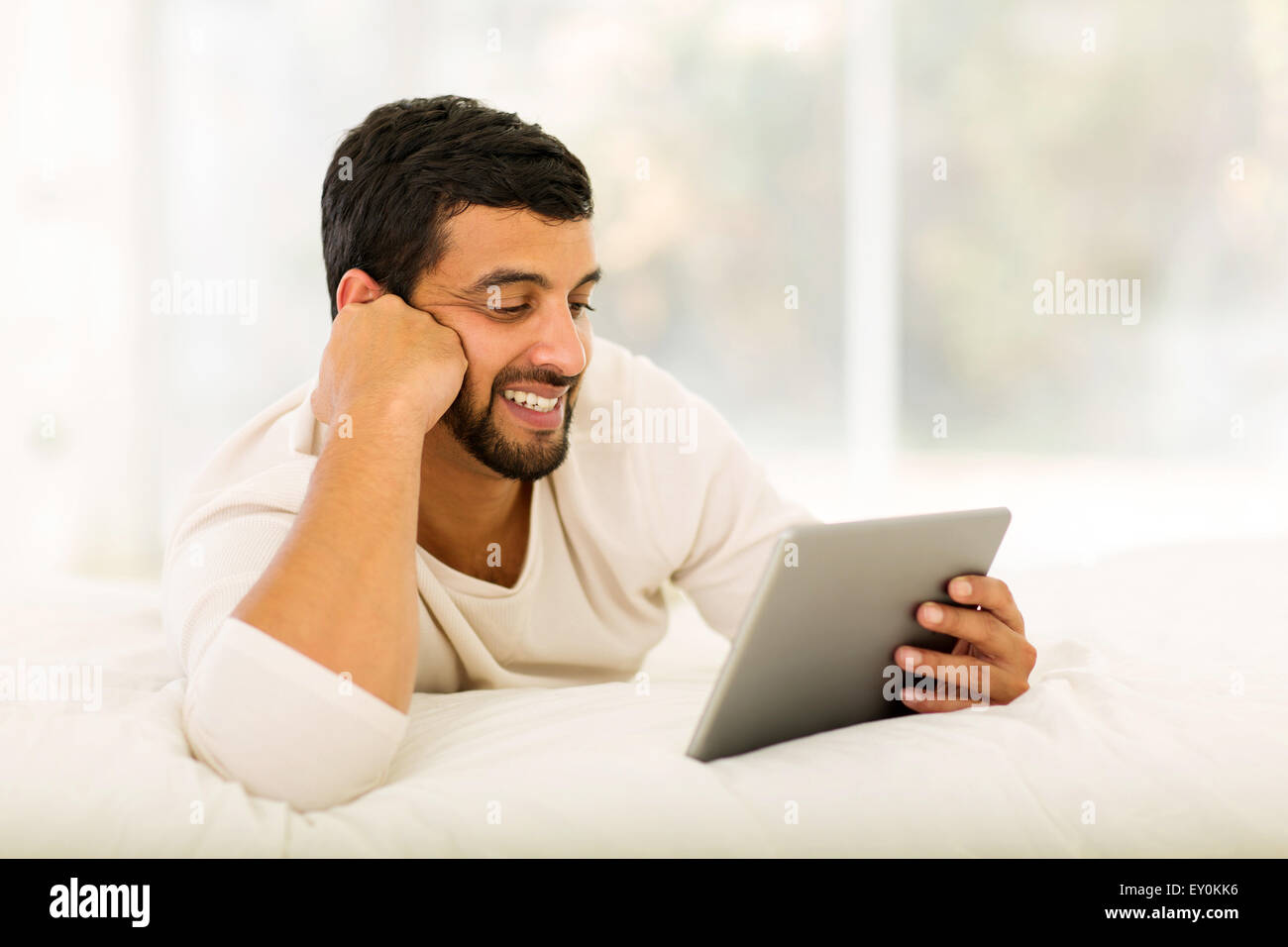 Indian guy reading tablet hi-res stock photography and images - Alamy