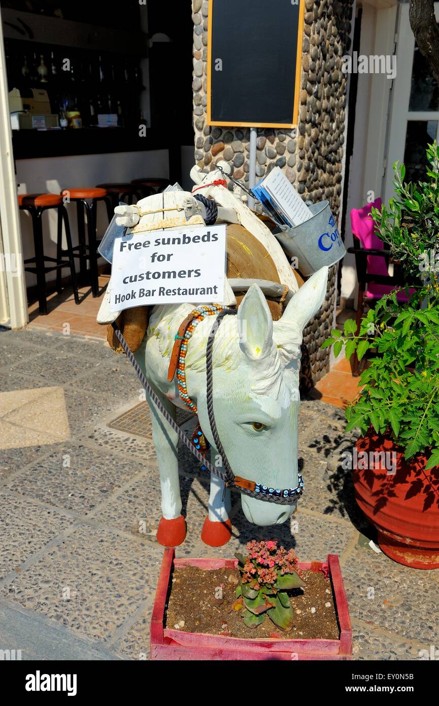 A donkey on display outside a restaurant advertising free sunbeds for ...
