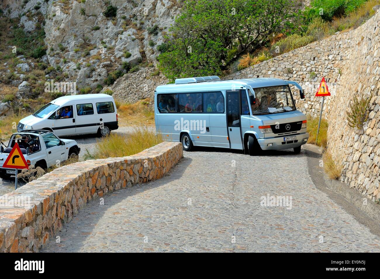 A minibus coach navigates the winding road up to the ancient city of ...