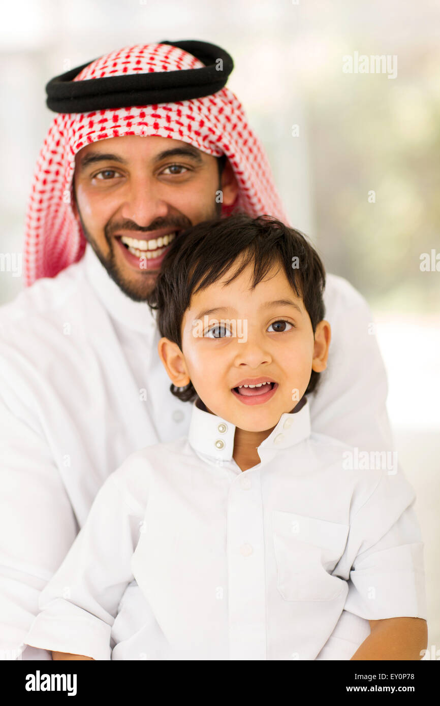 portrait of Arabian father and son sitting at home Stock Photo - Alamy