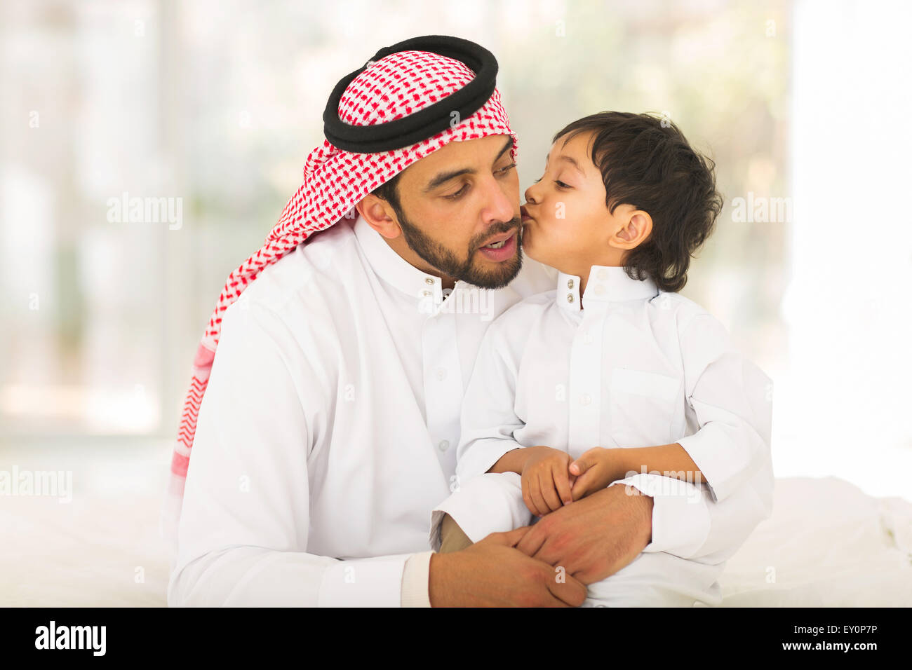 cute little Muslim boy kissing his father indoors Stock Photo - Alamy