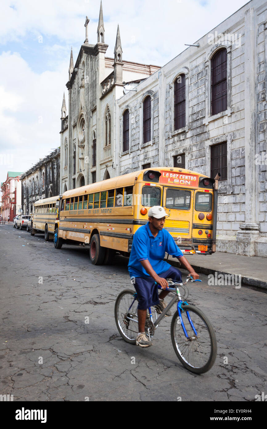 Biker and Yellow bus on the streets of León, Nicaragua Stock Photo - Alamy