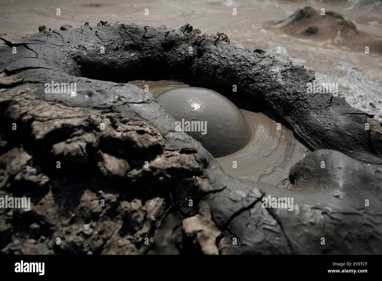 Mud bubbles and erupts from a mud volcano following a build-up of ...