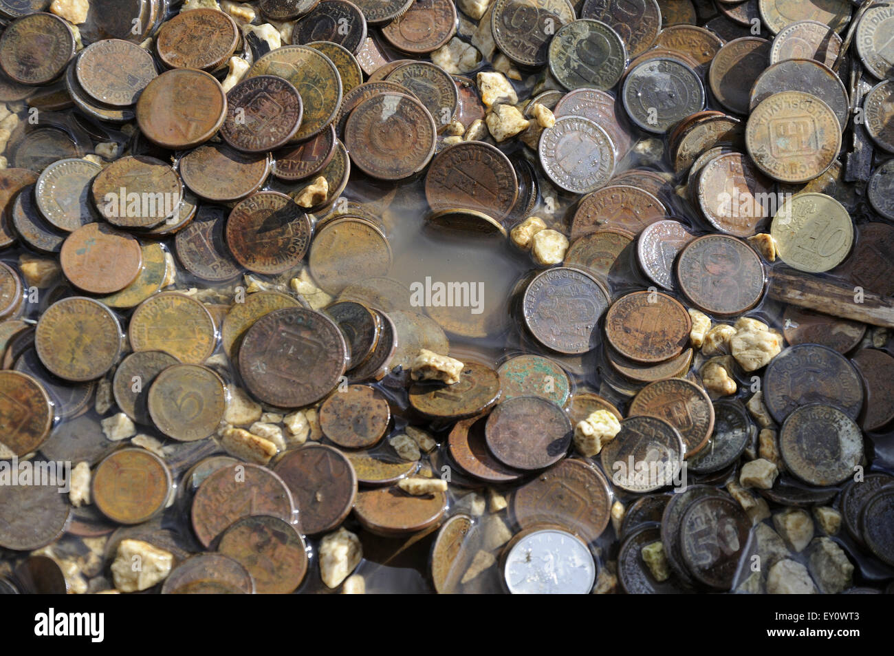 Old coins laying in the water Stock Photo - Alamy