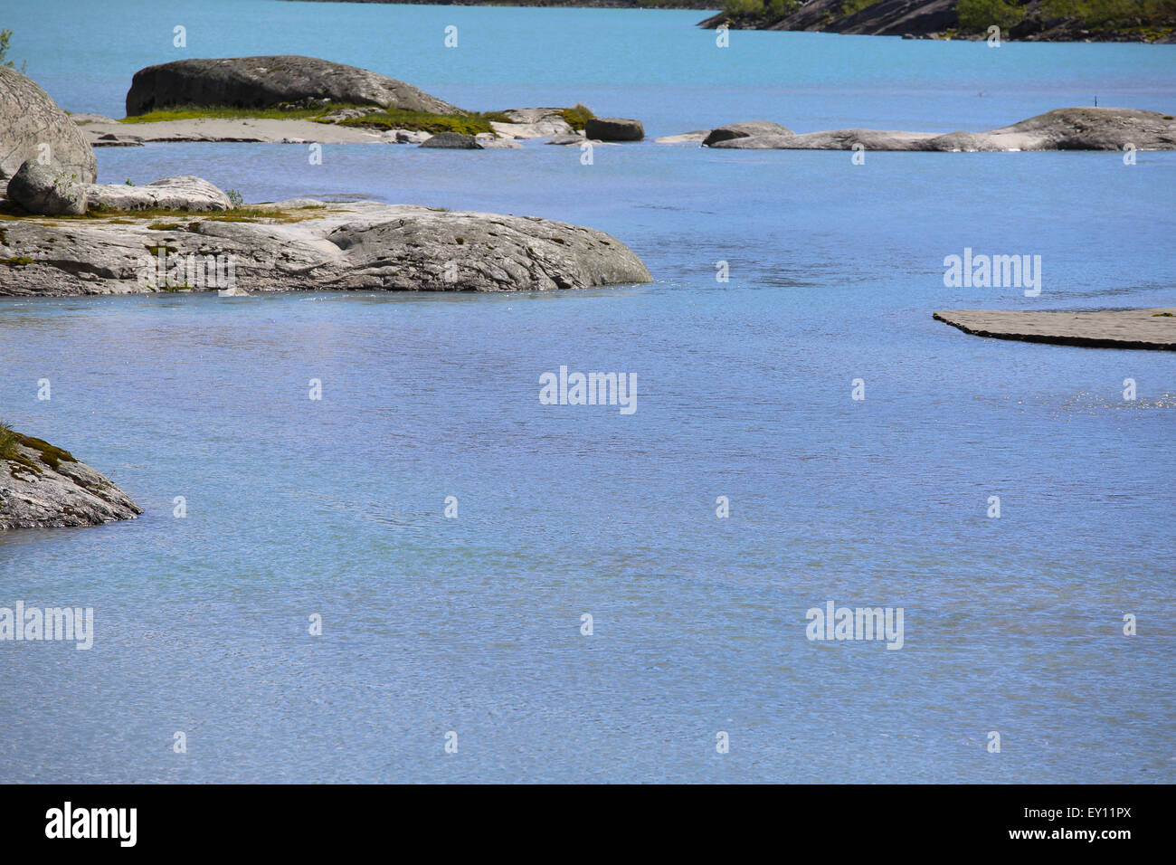Stones in pure blue glacial river in Norway Stock Photo - Alamy