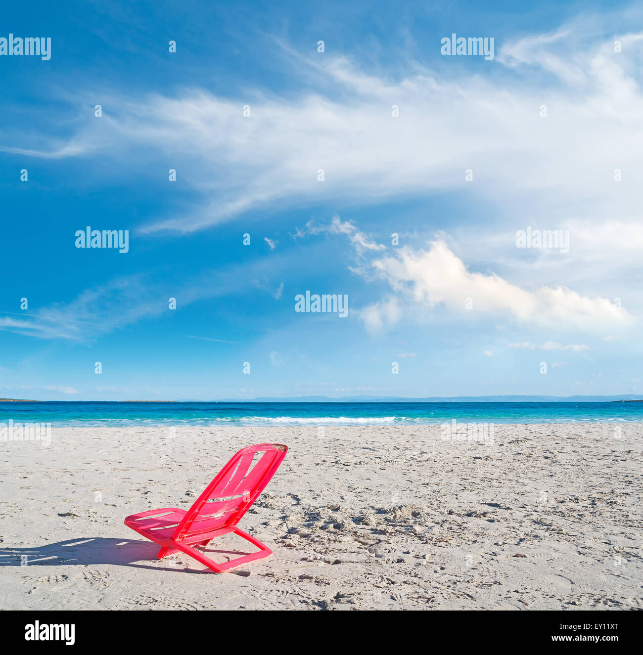 red beach chair on the sand Stock Photo - Alamy