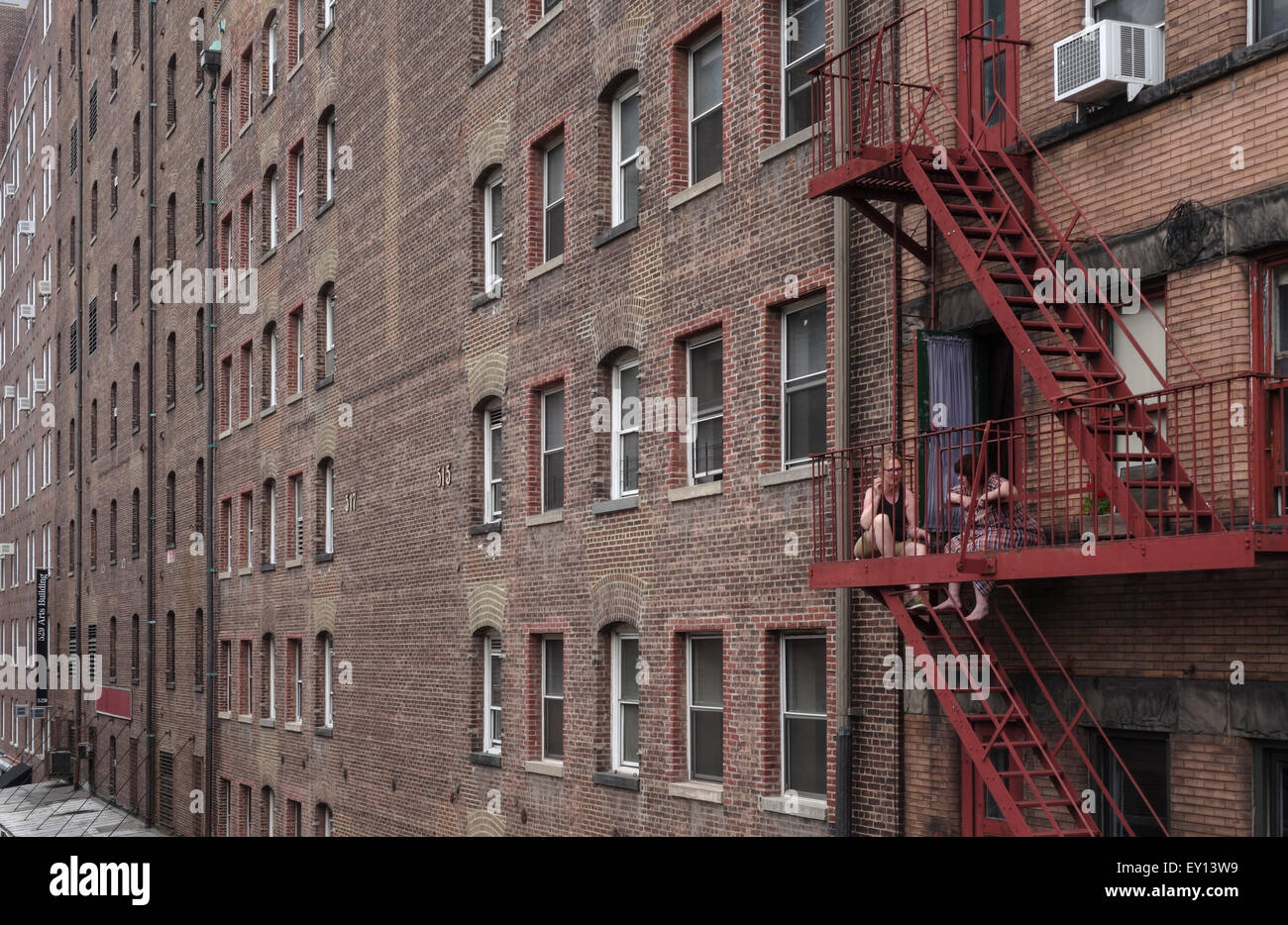 Two women sitting outside on fire escape, smoking, 529 arts Building ... Two women sitting outside on fire escape, smoking, 529 arts Building ...