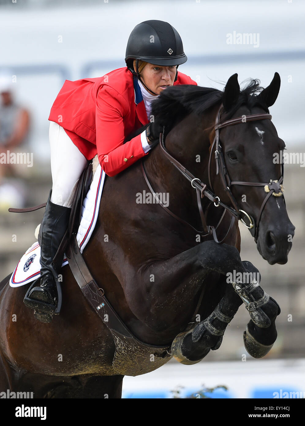 The American show jumper Elizabeth Madden goes over an obstacle on her ...