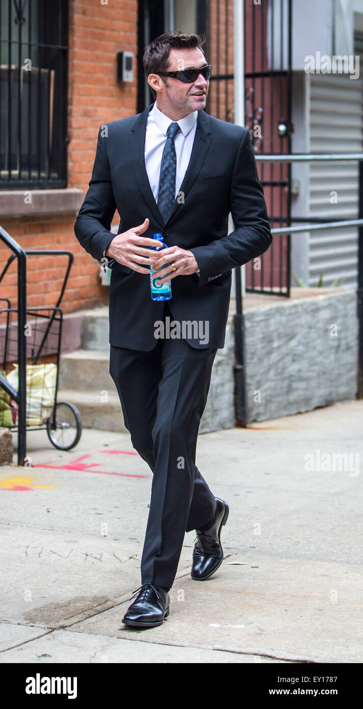 Hugh Jackman dressed in a suit leaving his home in New York City ...