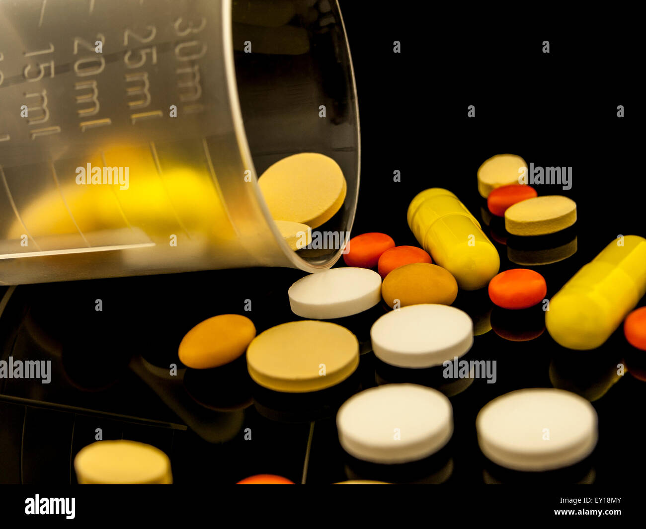 Medication/Pills/Tablets on black reflective background Stock Photo - Alamy