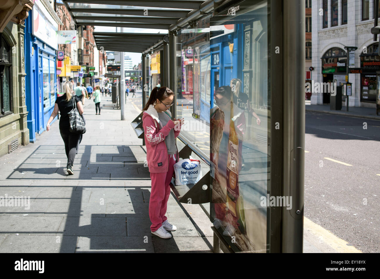 Girl Texting At Bus Stop Stock Photo - Alamy