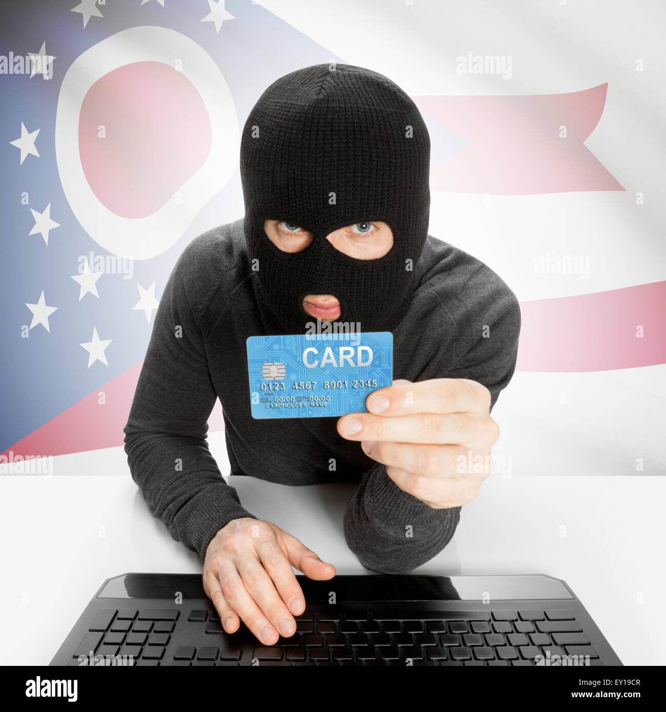 Hacker in black mask with USA state flag - Ohio Stock Photo - Alamy