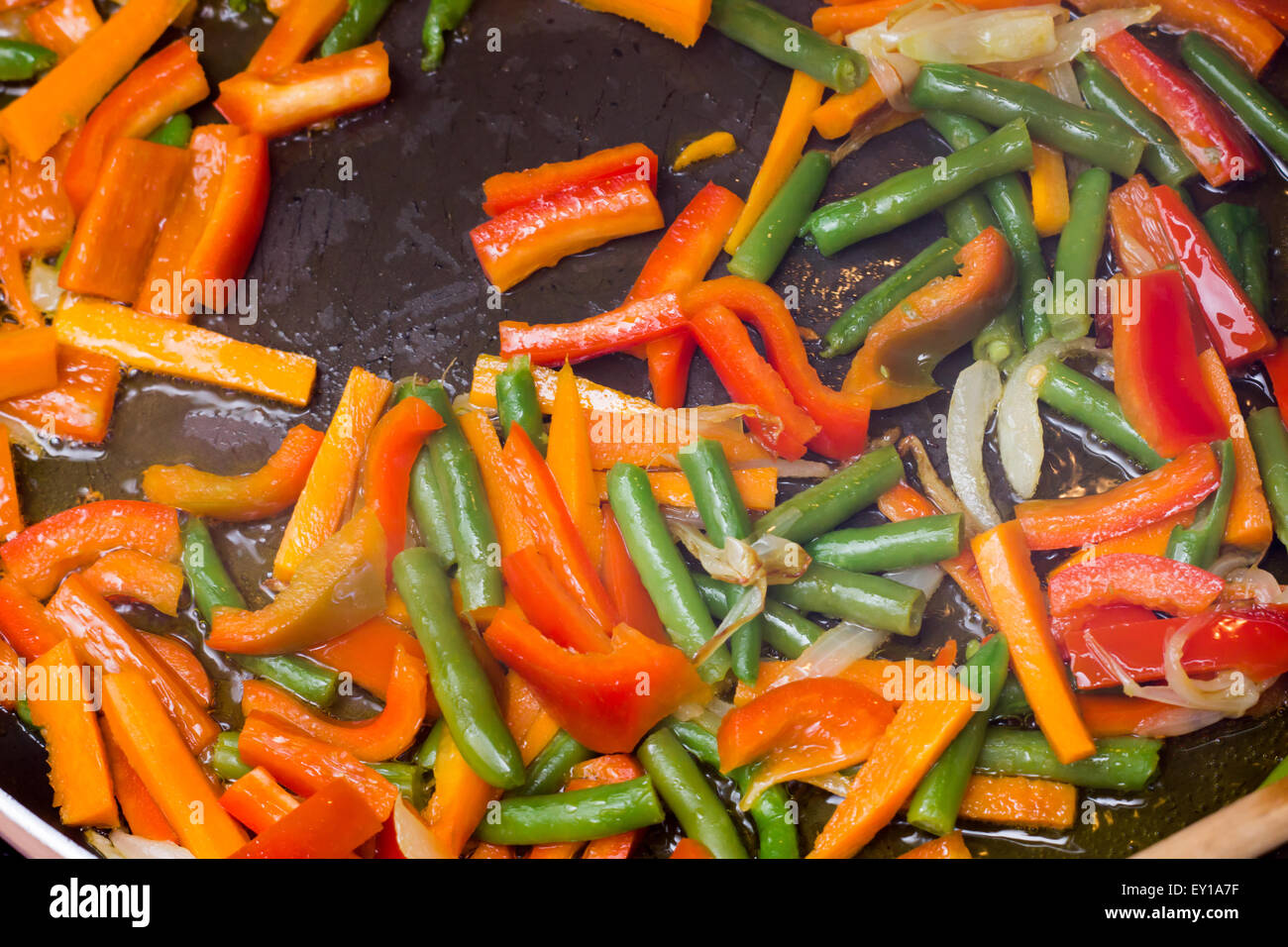 Vegetables cut into strips sauteed with oil seen from above Stock Photo ...