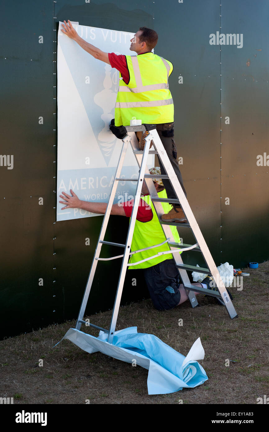 workers putting up posters for the americas cup in southsea hampshire ...