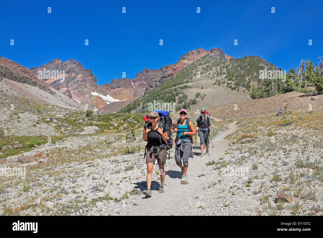 Female college students backpacking in the alpine areas of the Oregon ...