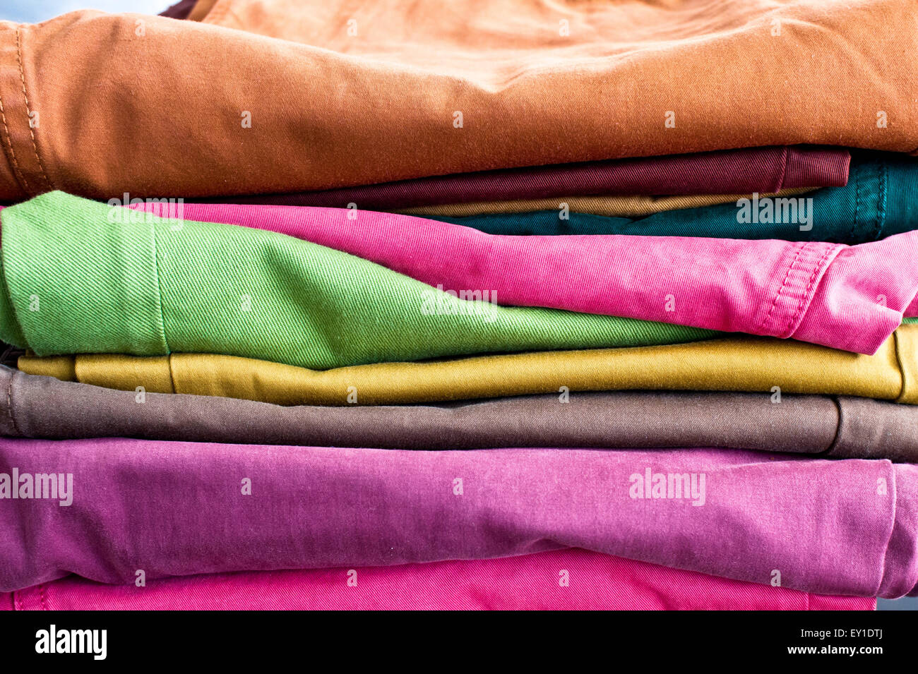 Stack of colorful casual trousers, as a background Stock Photo - Alamy