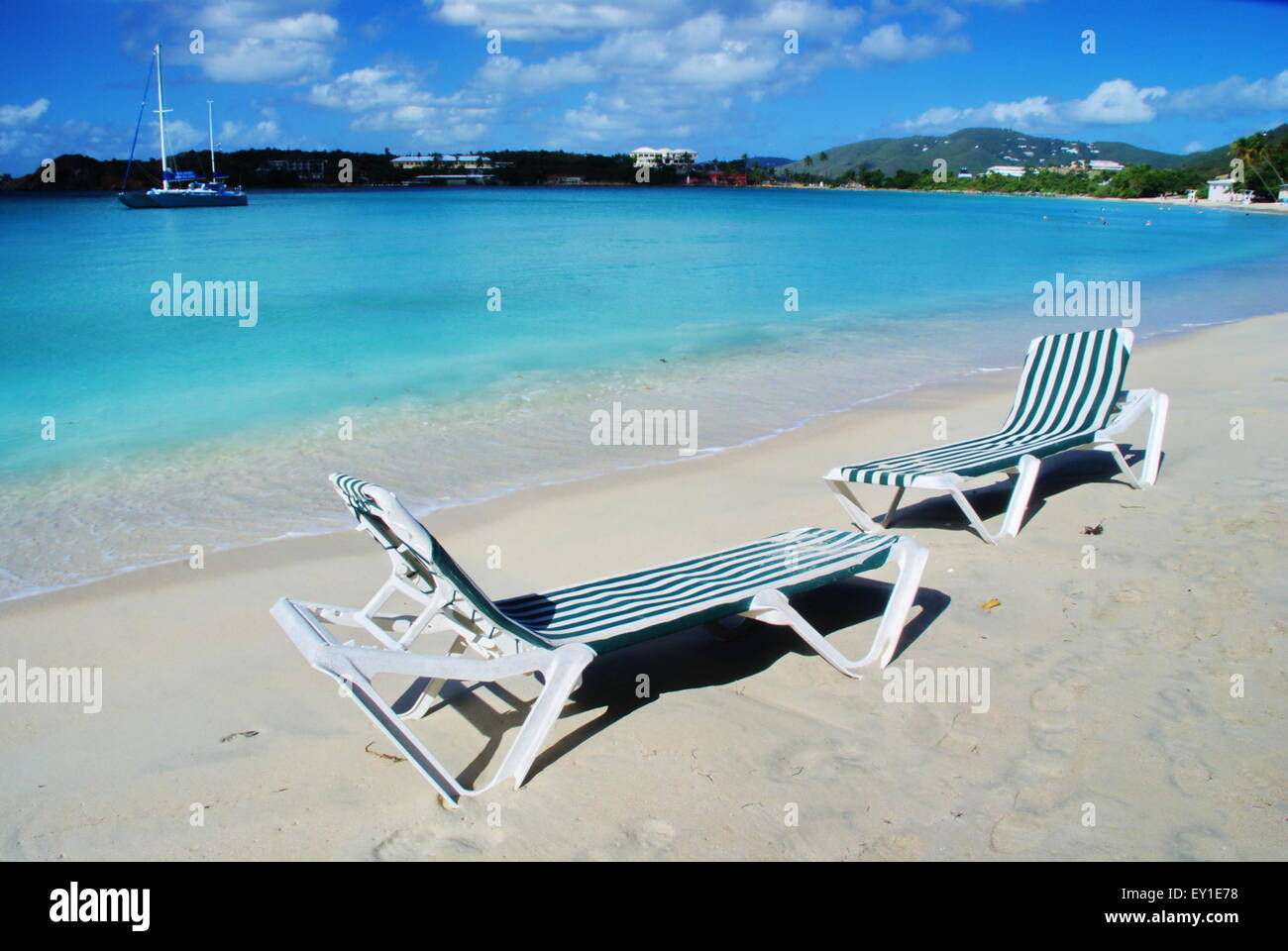 Two green and white striped chaise lounges on Caribbean beach with ...