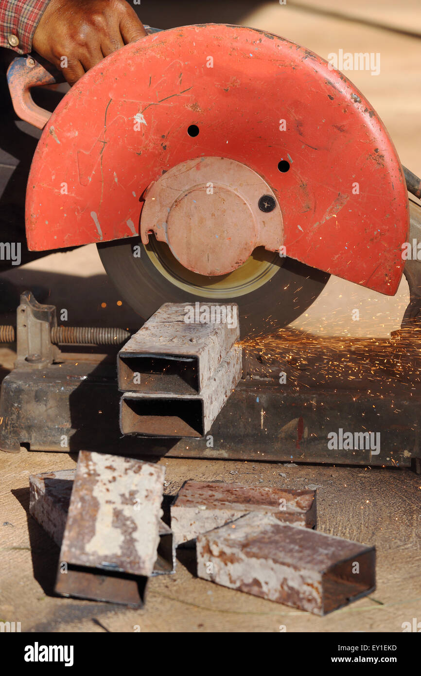 cutting a metal and steel with compound mitre saw with sharp, circular ...