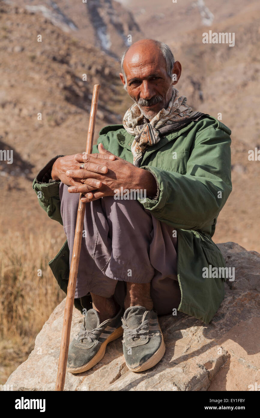 Old shepherd resting on a rock Stock Photo - Alamy