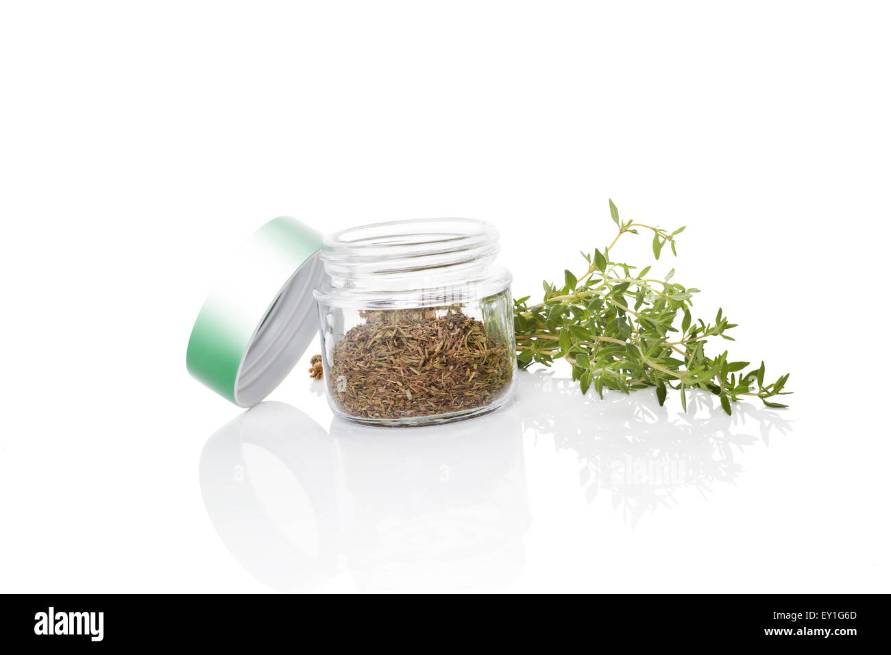 Fresh thyme and dry thyme spice in glass jar isolated on white ...