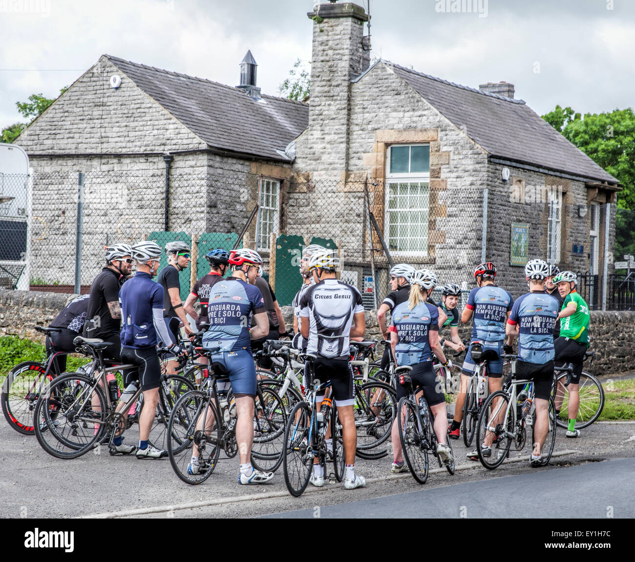 Group of cyclists stop by the side of the road waiting to set off on a ...
