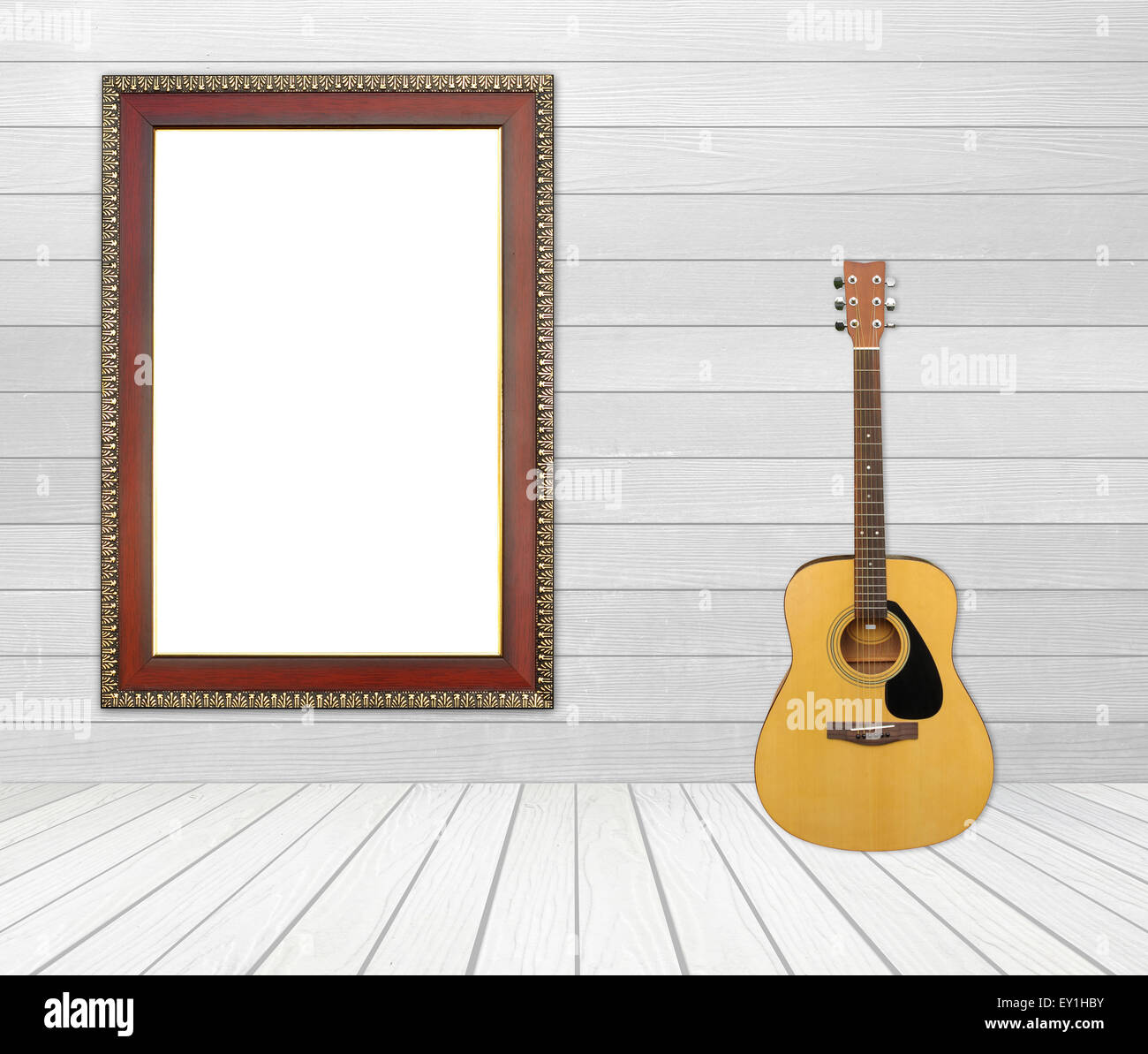 Guitar and picture frame in white room Stock Photo - Alamy