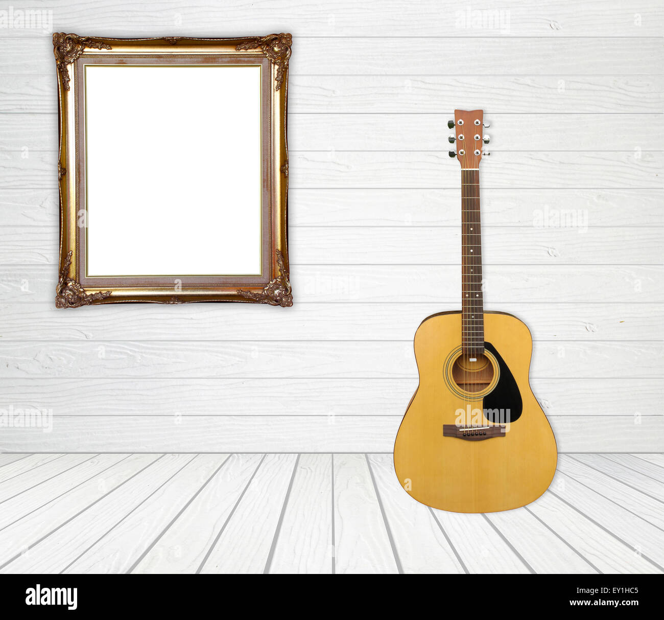 Guitar and picture frame in white room Stock Photo - Alamy