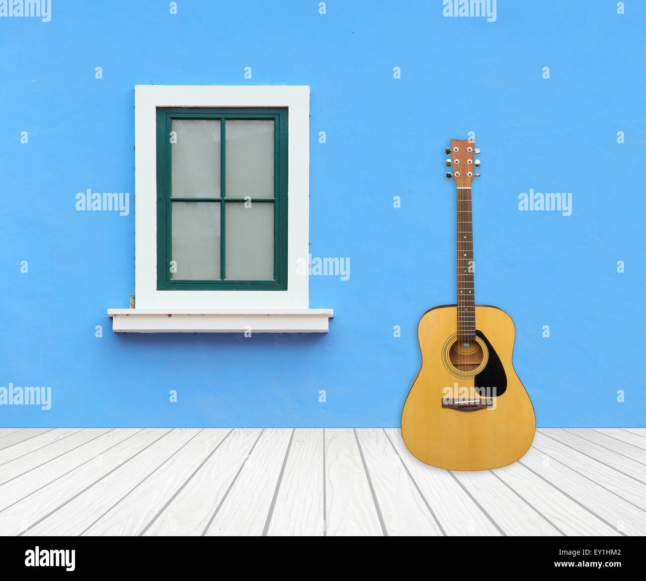 Guitar with window on cement wall and wood floor Stock Photo - Alamy