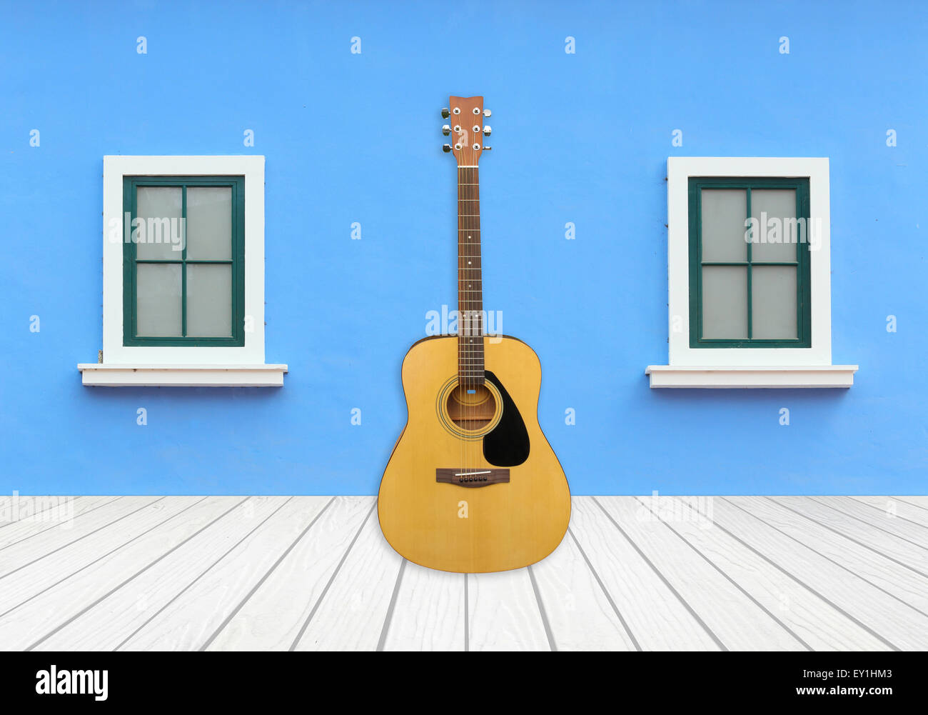 Guitar with window on cement wall and wood floor Stock Photo - Alamy