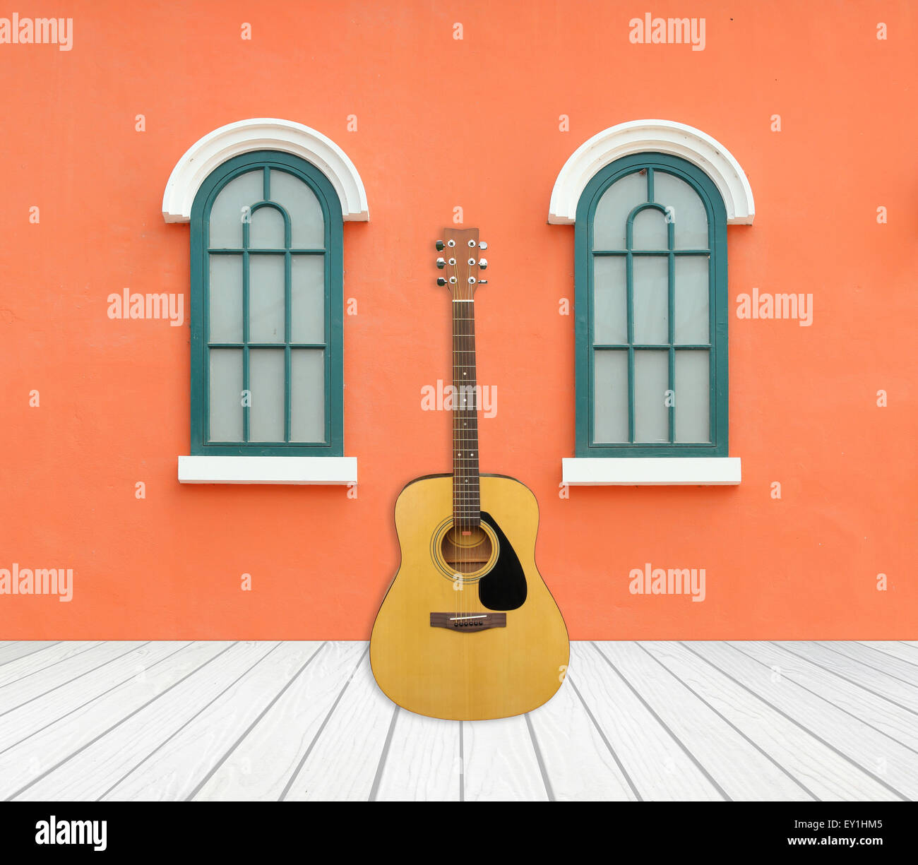 Guitar with window on cement wall and wood floor Stock Photo - Alamy