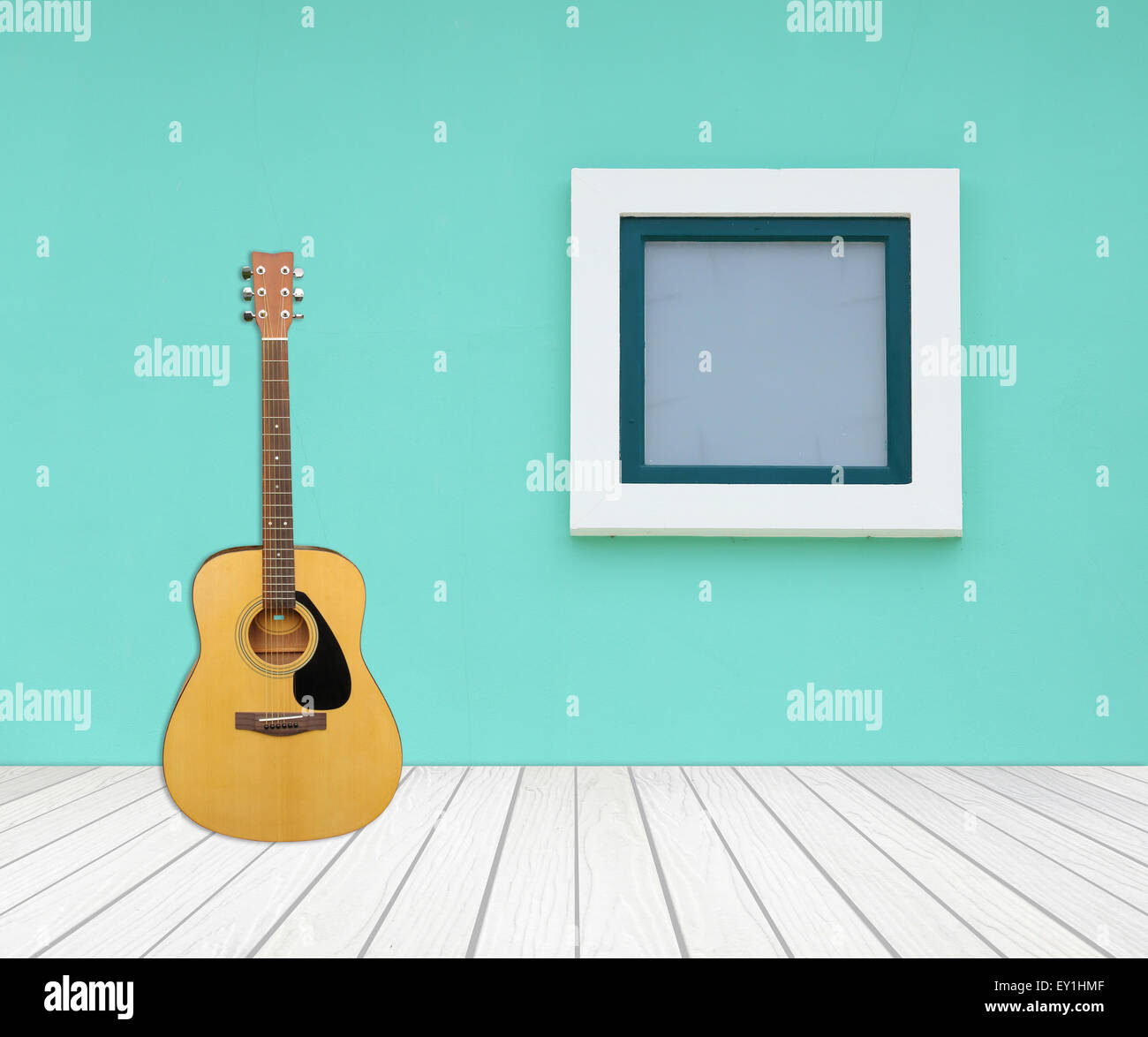 Guitar with window on cement wall and wood floor Stock Photo - Alamy